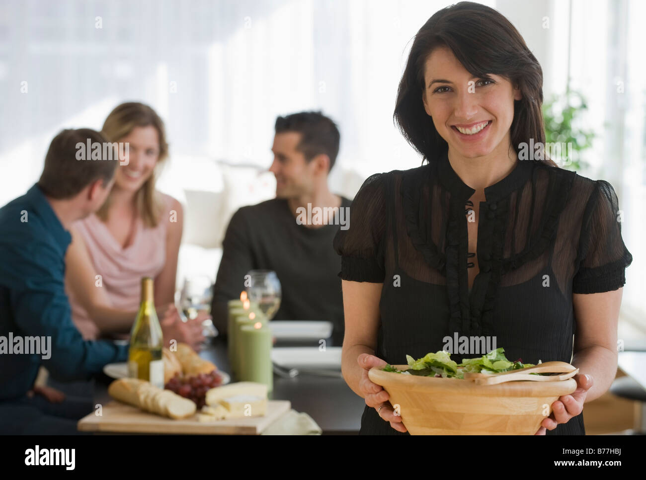 Portrait of woman holding salad bowl friends background Stock Photo - Alamy