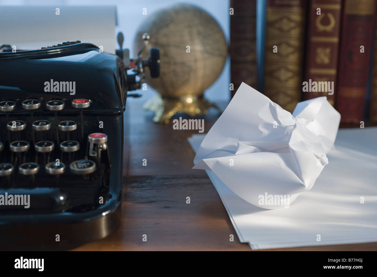 Crumpled paper next to antique typewriter Stock Photo - Alamy