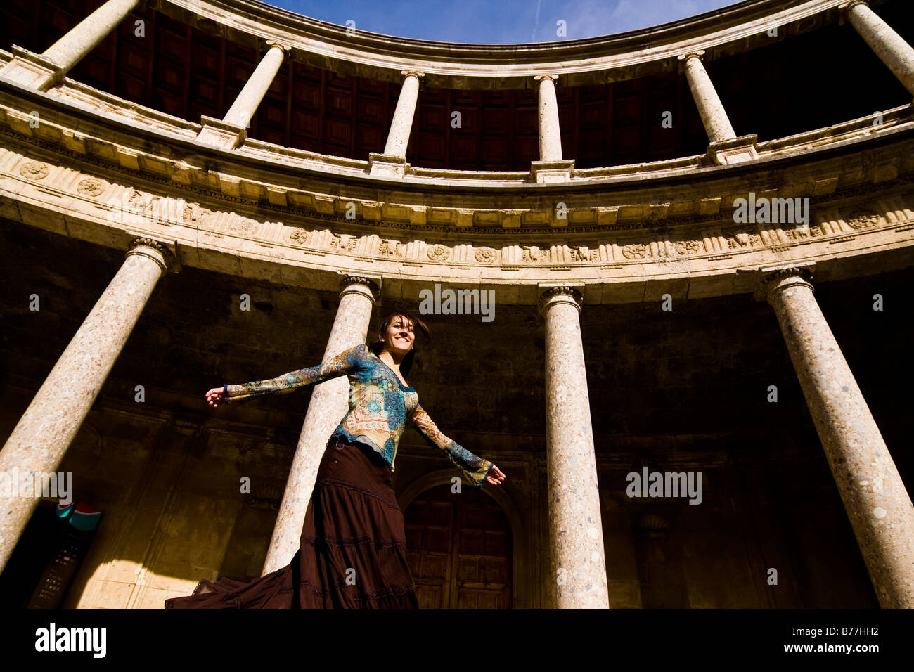 Happy young woman dancing in monumental building Stock Photo - Alamy