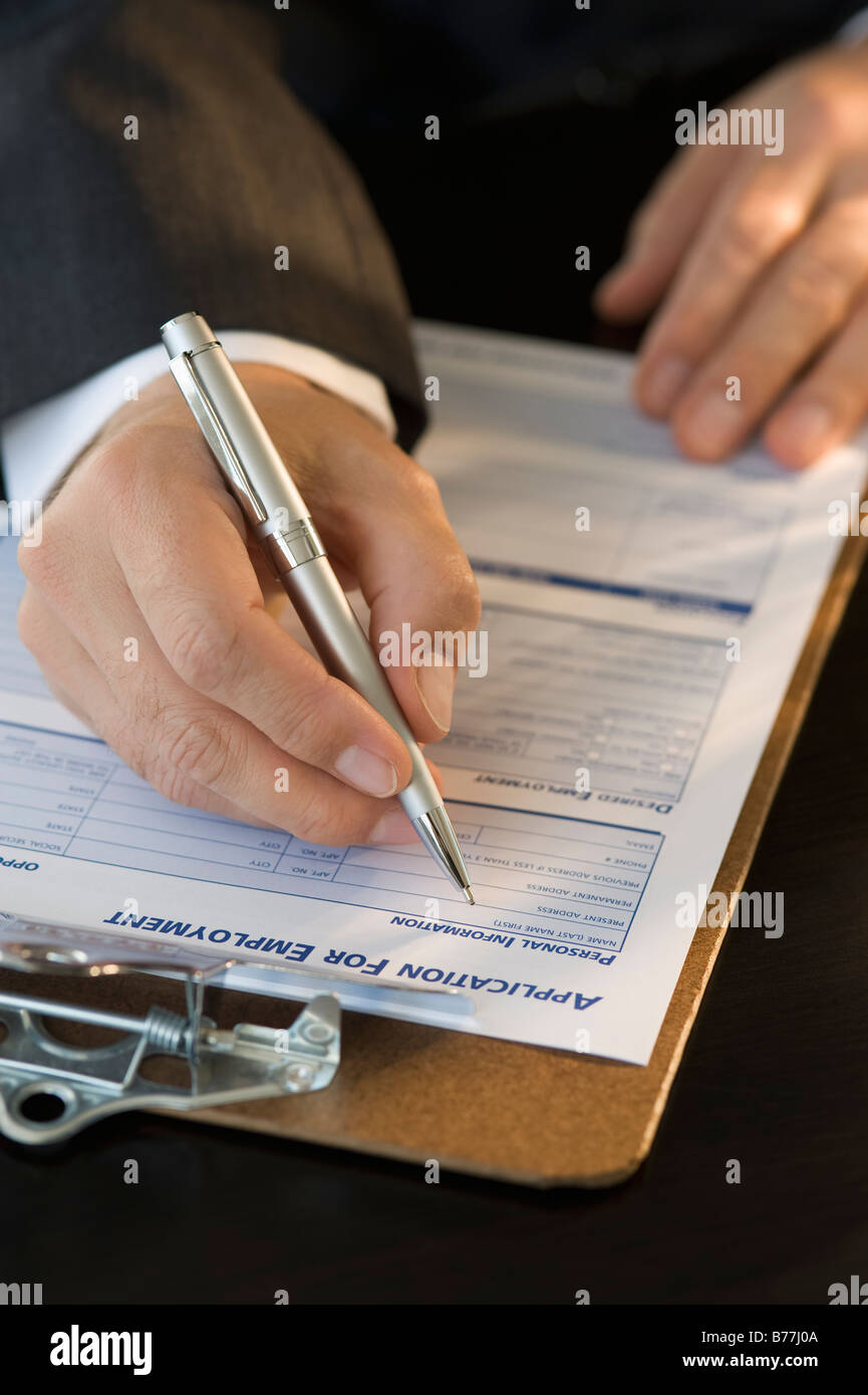 Man filling out employment application Stock Photo - Alamy