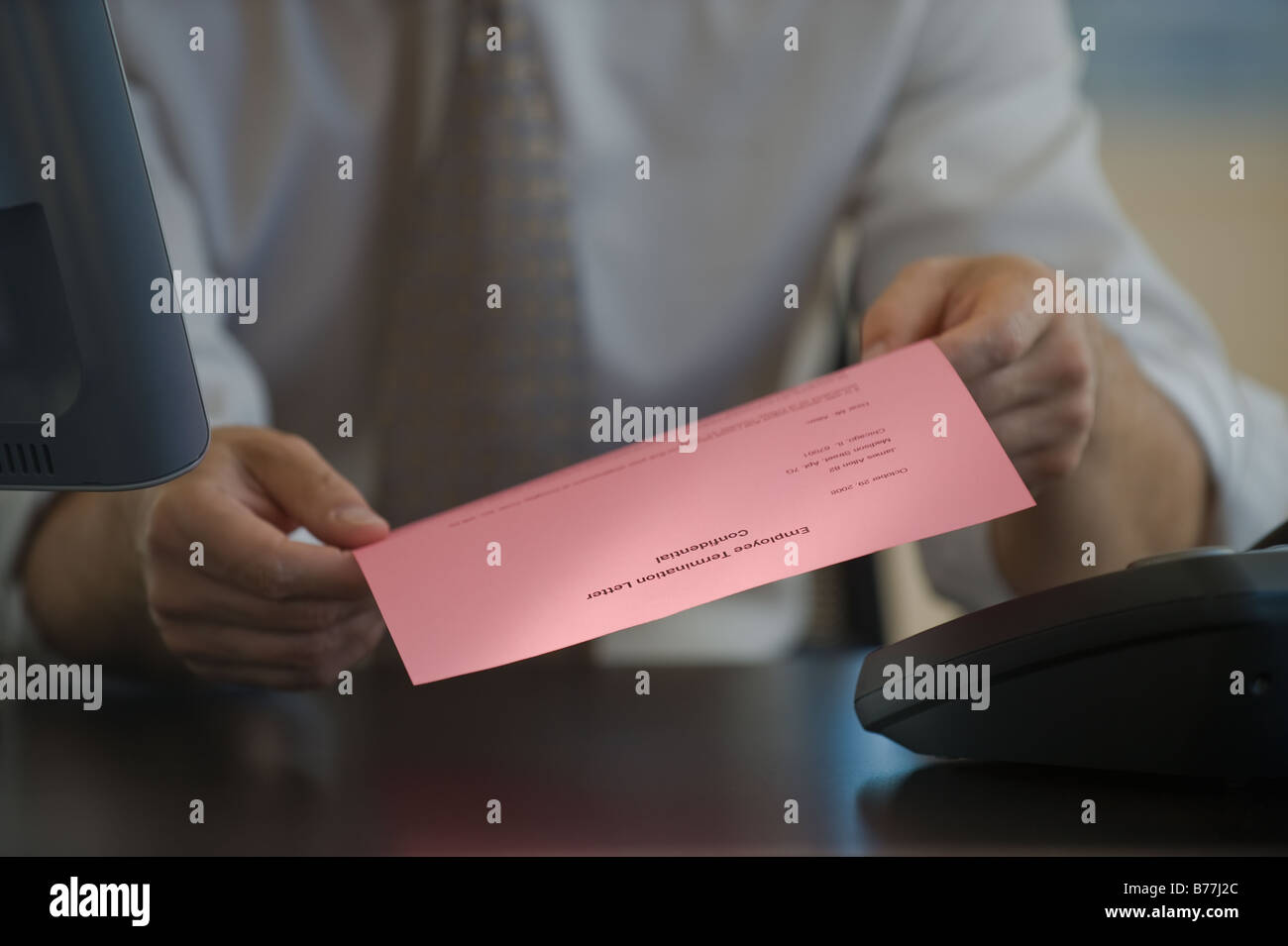 Man holding pink slip Stock Photo - Alamy