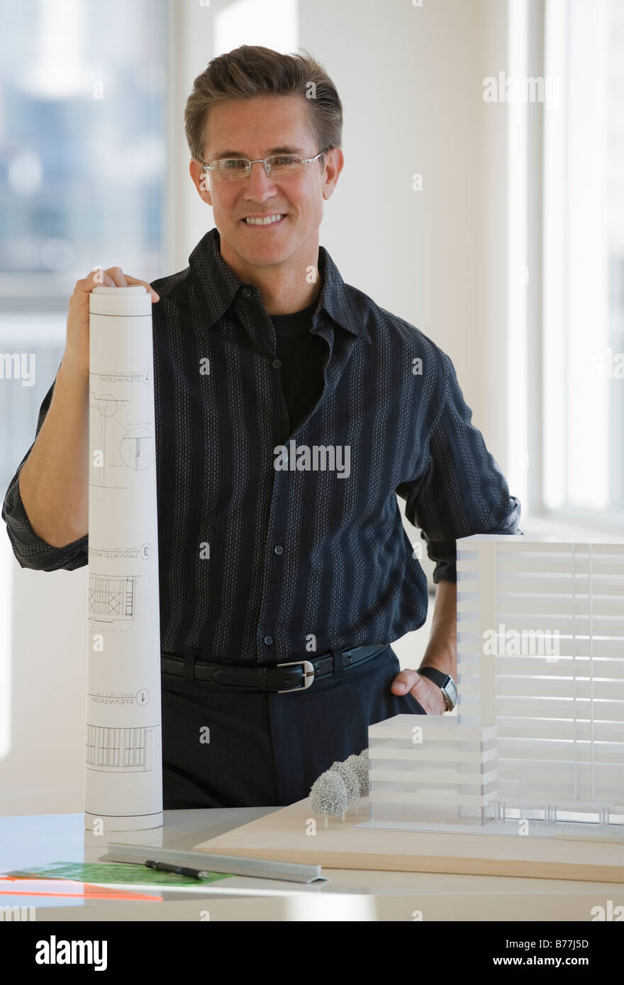 Portrait of architect blueprint and building model Stock Photo - Alamy