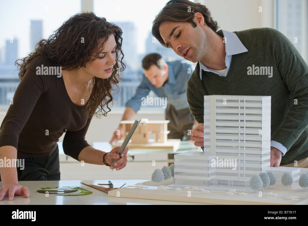 Architects constructing building model Stock Photo - Alamy