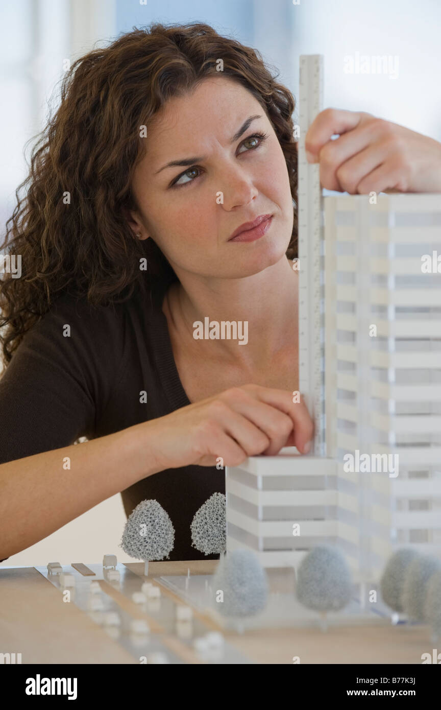 Close up of architect measuring building model Stock Photo - Alamy