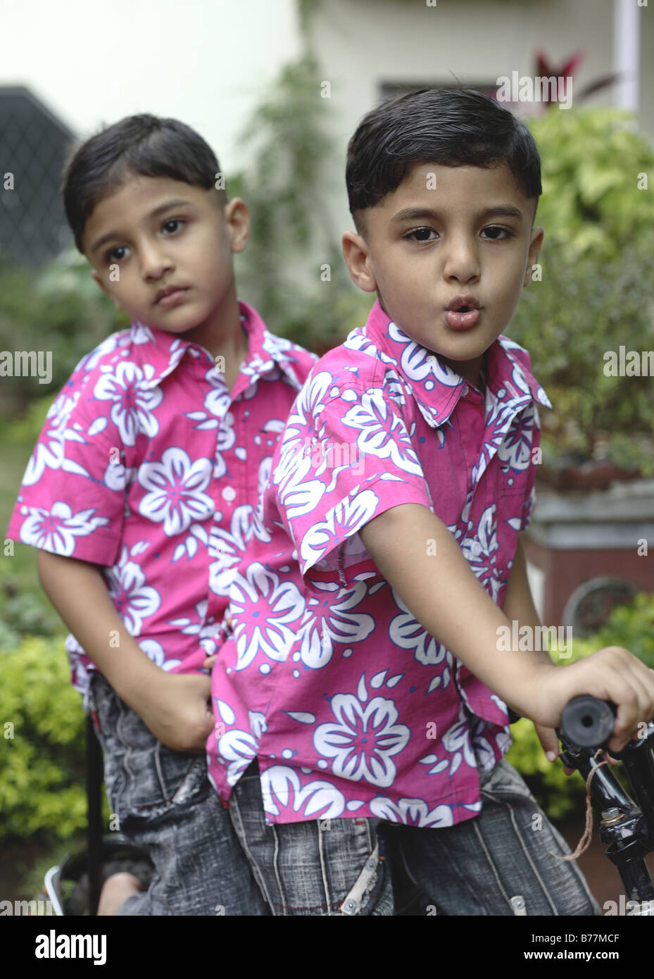 Twin brothers riding bicycle ; Jabalpur ; Madhya Pradesh ; India MR#372 ...