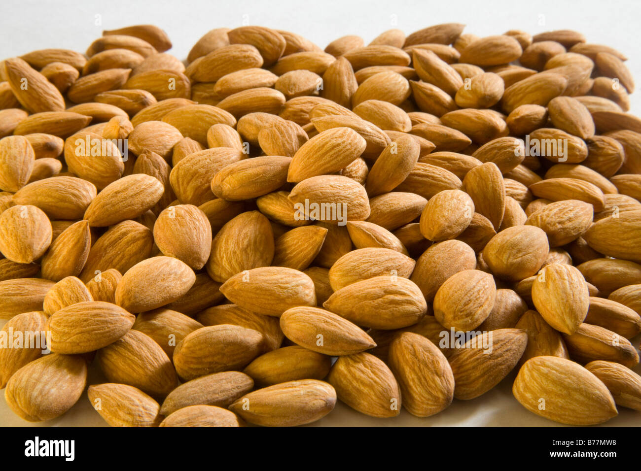 Dry fruit ; whole Almonds nuts Badam Prunus dulcis on white background ...