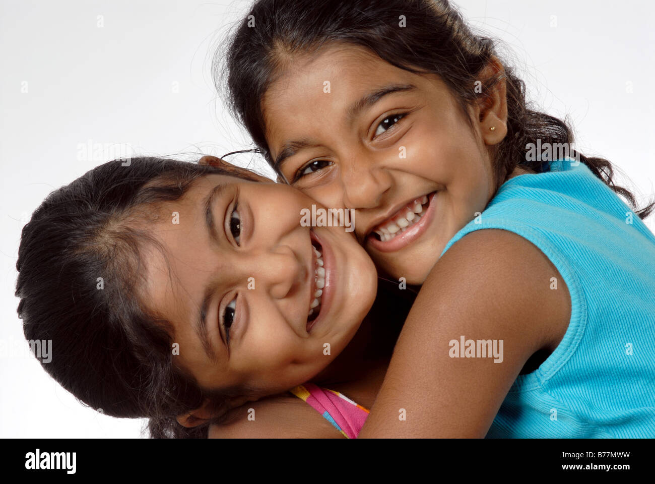 South Asian Indian two girls hugging each other and laughing MR#364 ...