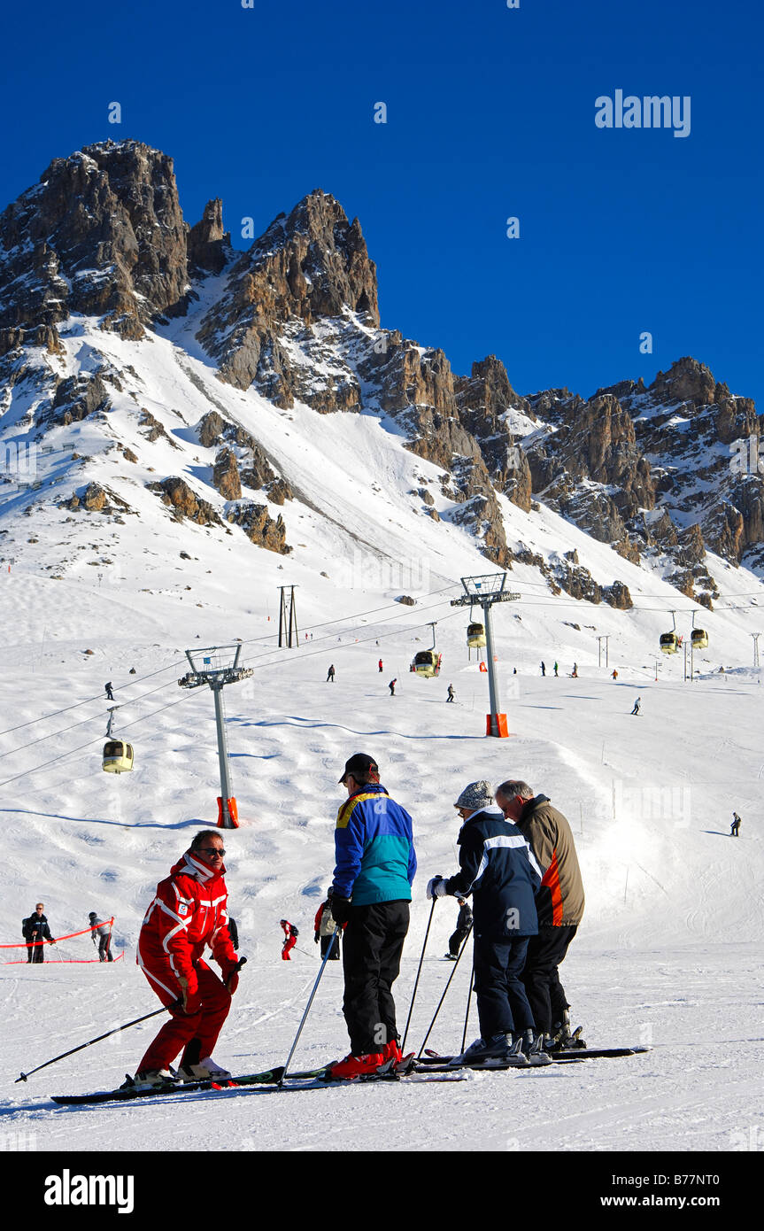 Ski-teacher showing ski pupils the correct posture on the skis, skiing ...