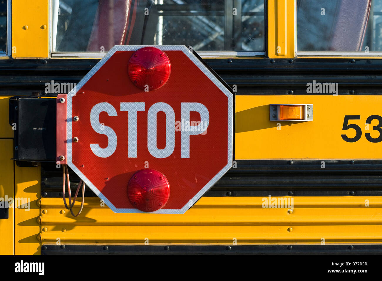 School bus with retracting safety stop sign Stock Photo - Alamy