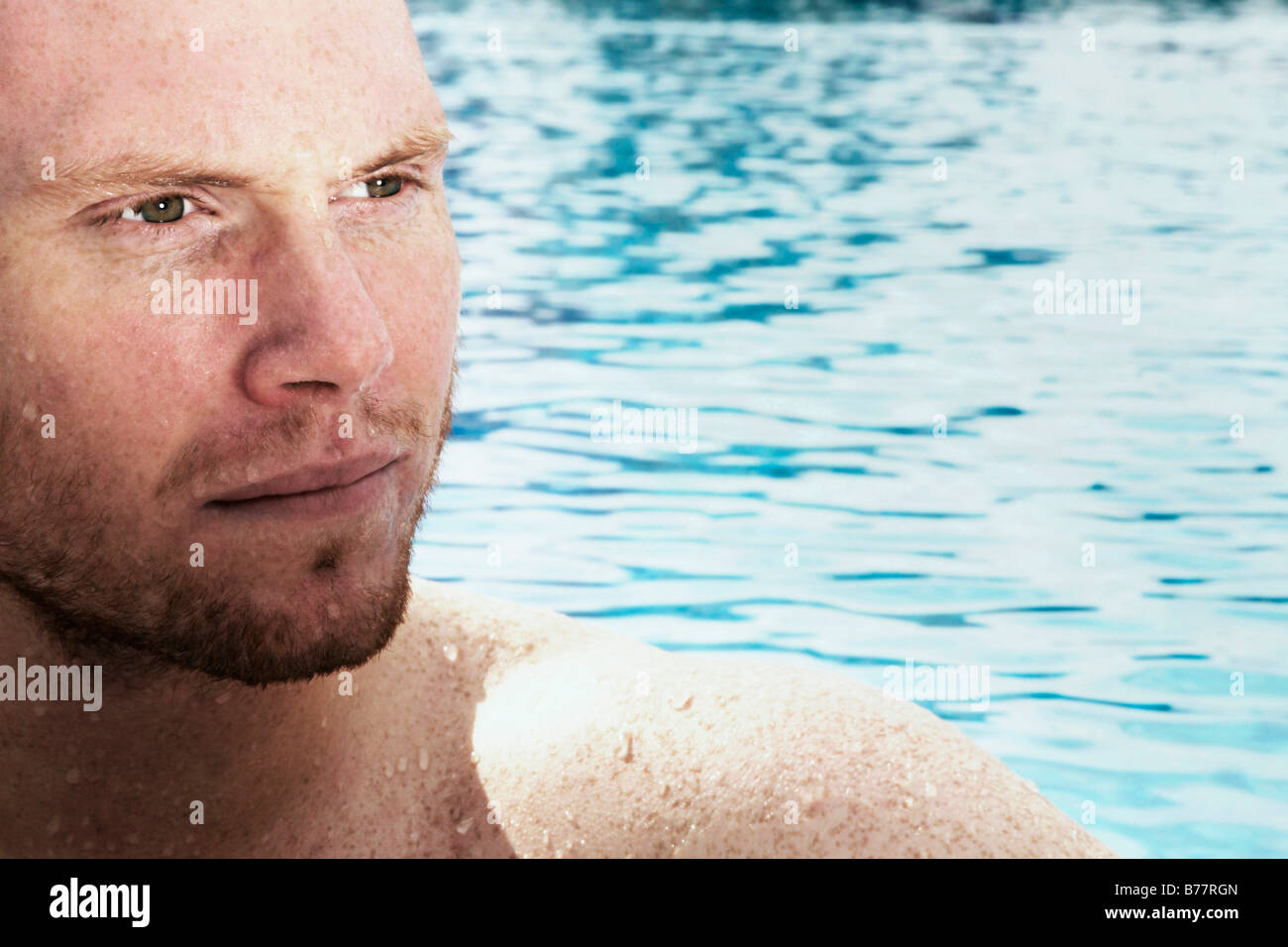 Young man by the swimming pool Stock Photo - Alamy