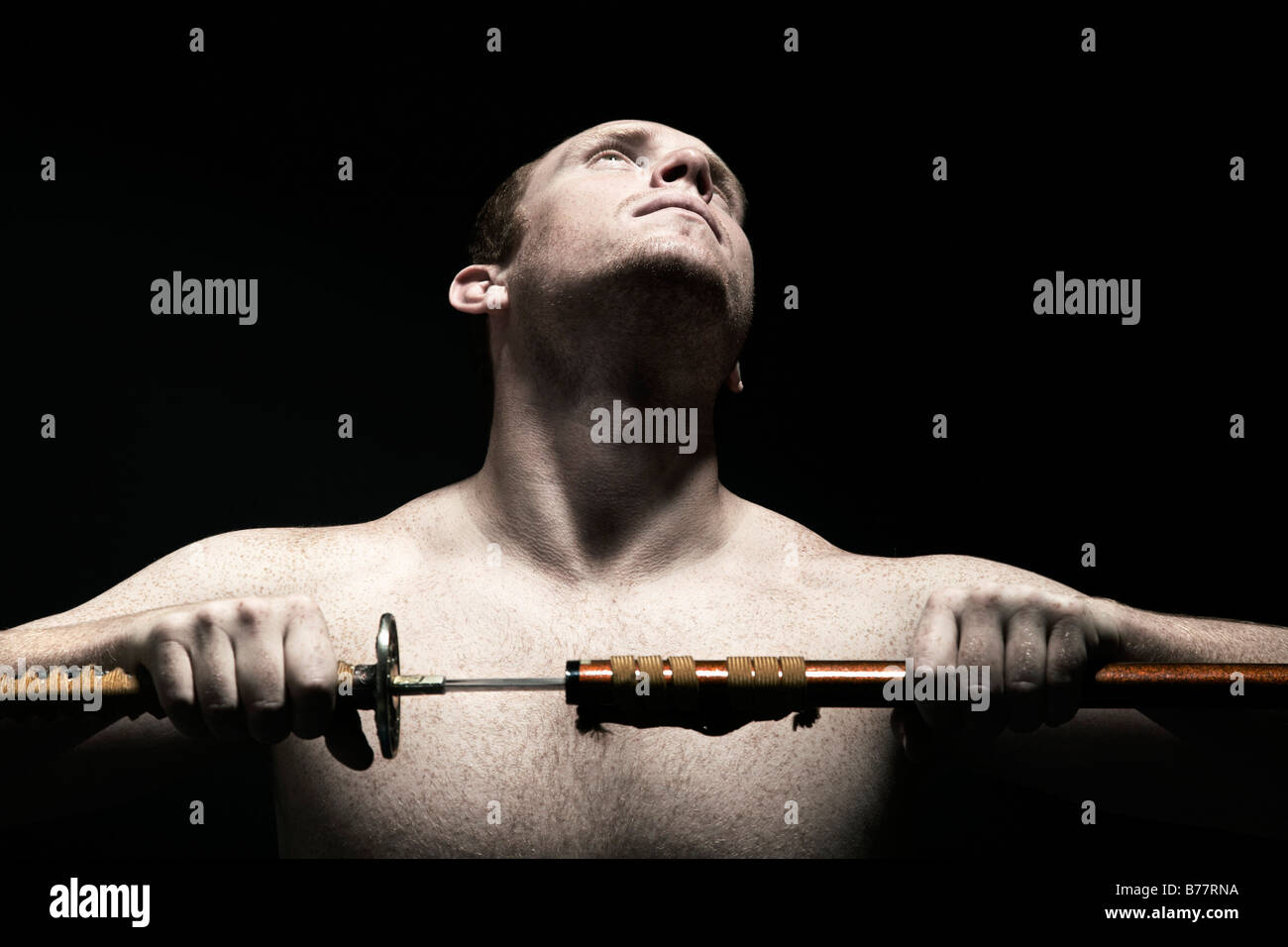 Man with a sword, preparing for a fight Stock Photo - Alamy