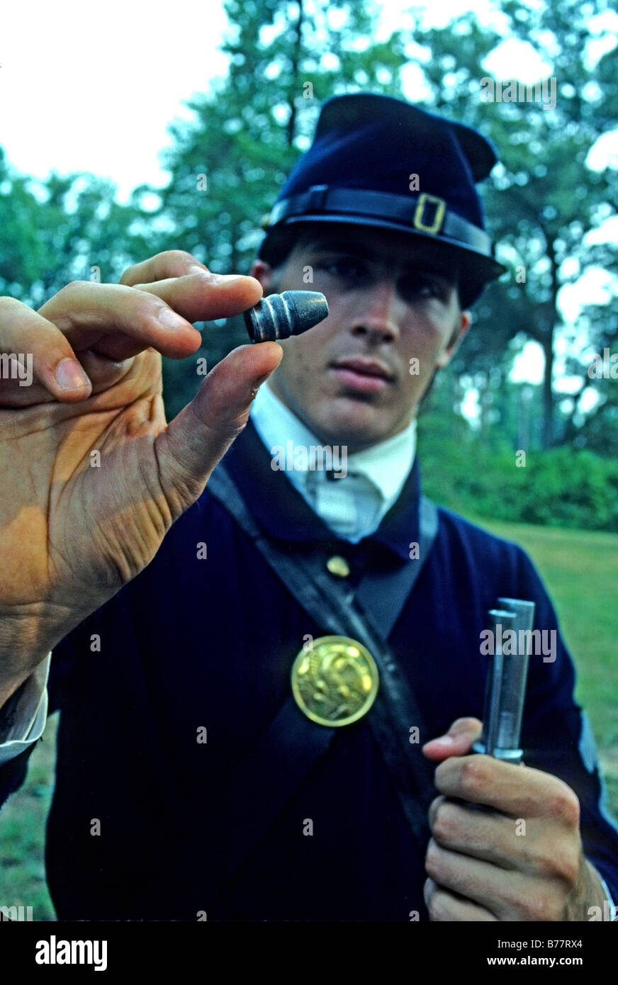 Era dressed civil war soldier shows rifle slug National Battlefield ...