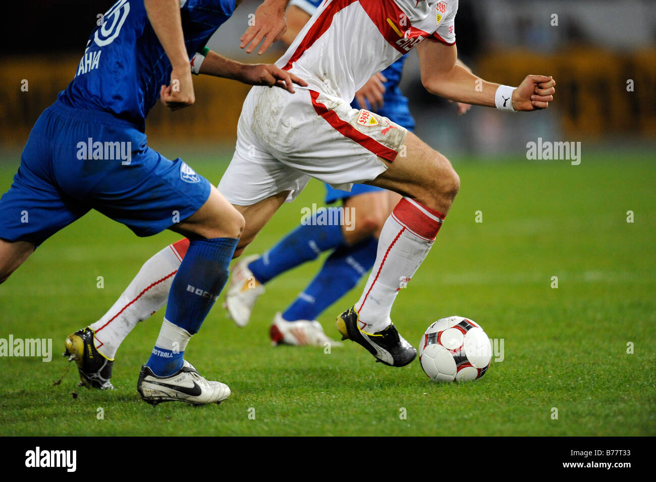 Football players battle for the ball, partial view Stock Photo - Alamy