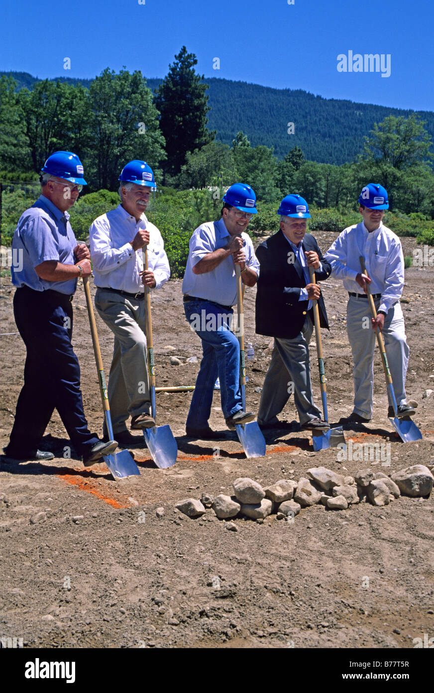 Business executives at new building construction ground breaking ...