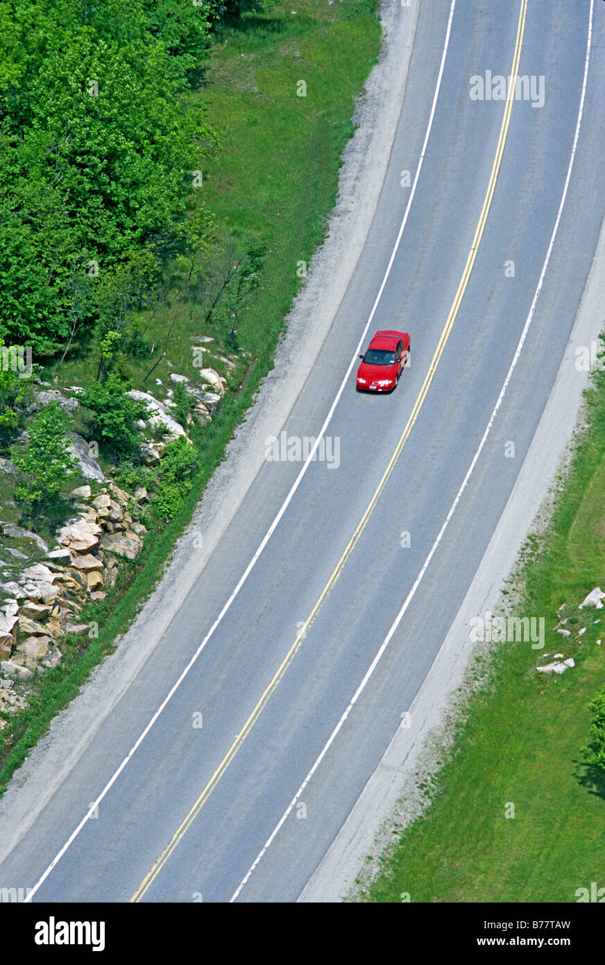 Aerial view of red car moving on two lane highway in countryside Stock ...