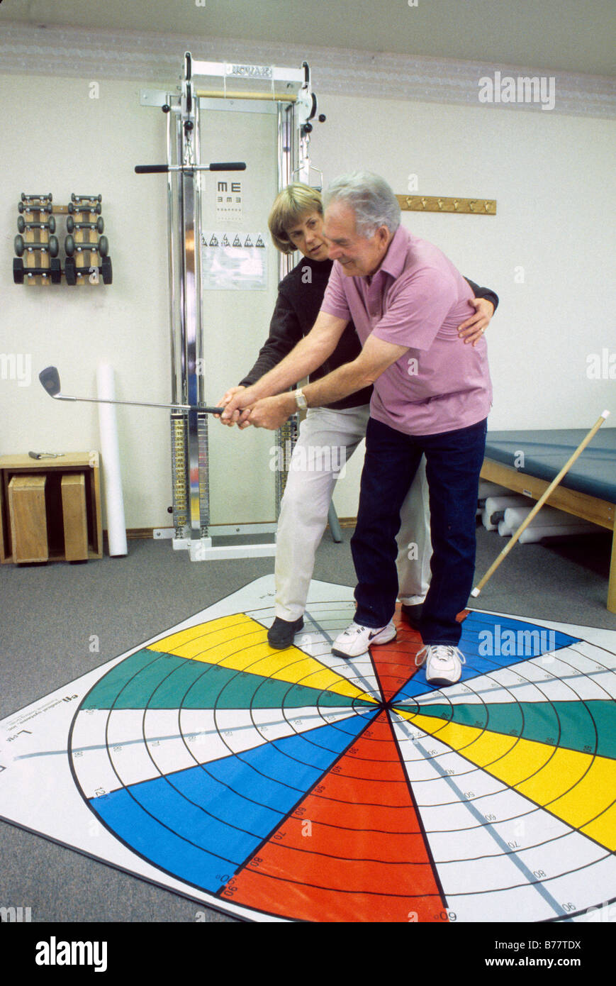 Released,physical therapist assists senior man on lower extremity grid ...