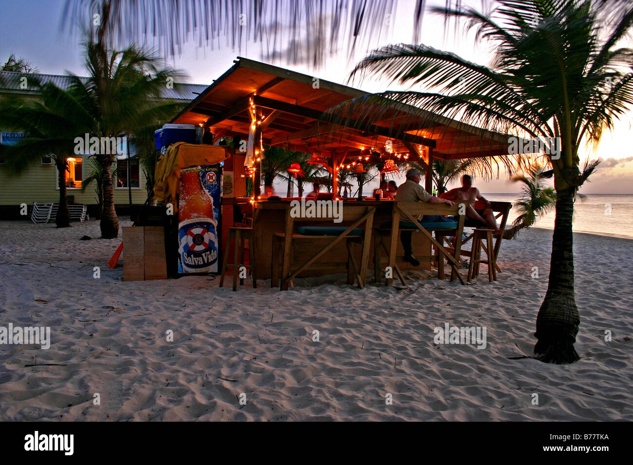 People enjoying cocktails at Infinity Bay Beach Bar,dusk,West Bay Beach ...