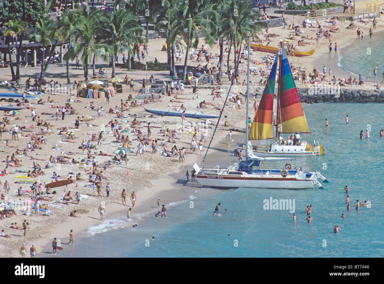 Wakiki Beach with people and colorful sailboat Hawaii Stock Photo - Alamy