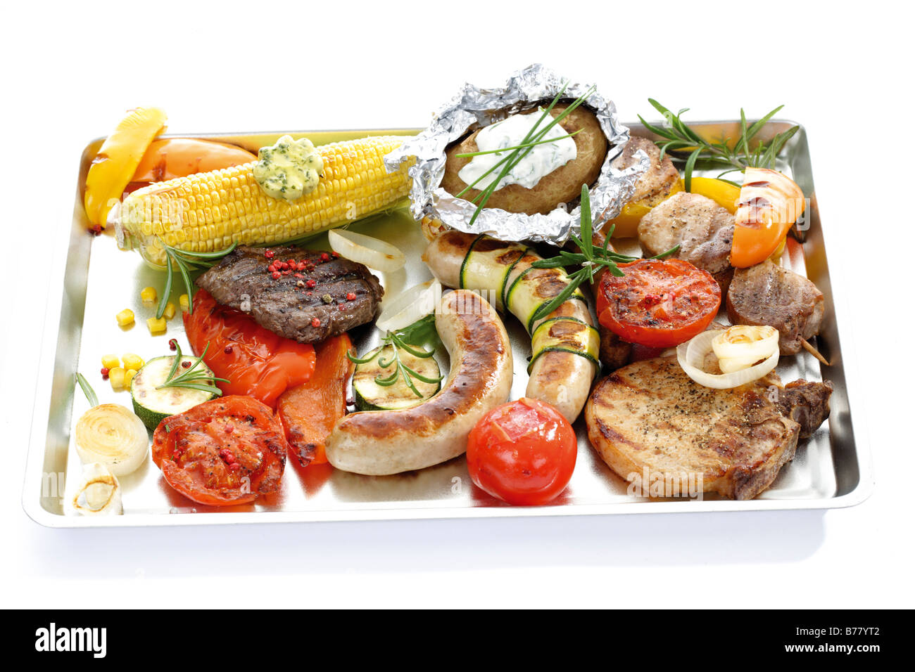Grilled meat, sausage and vegetables on tray Stock Photo - Alamy