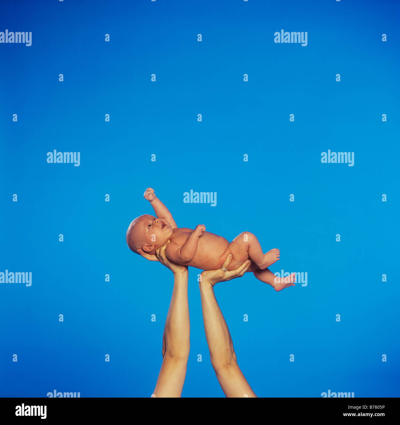 Baby held aloft hi-res stock photography and images - Alamy