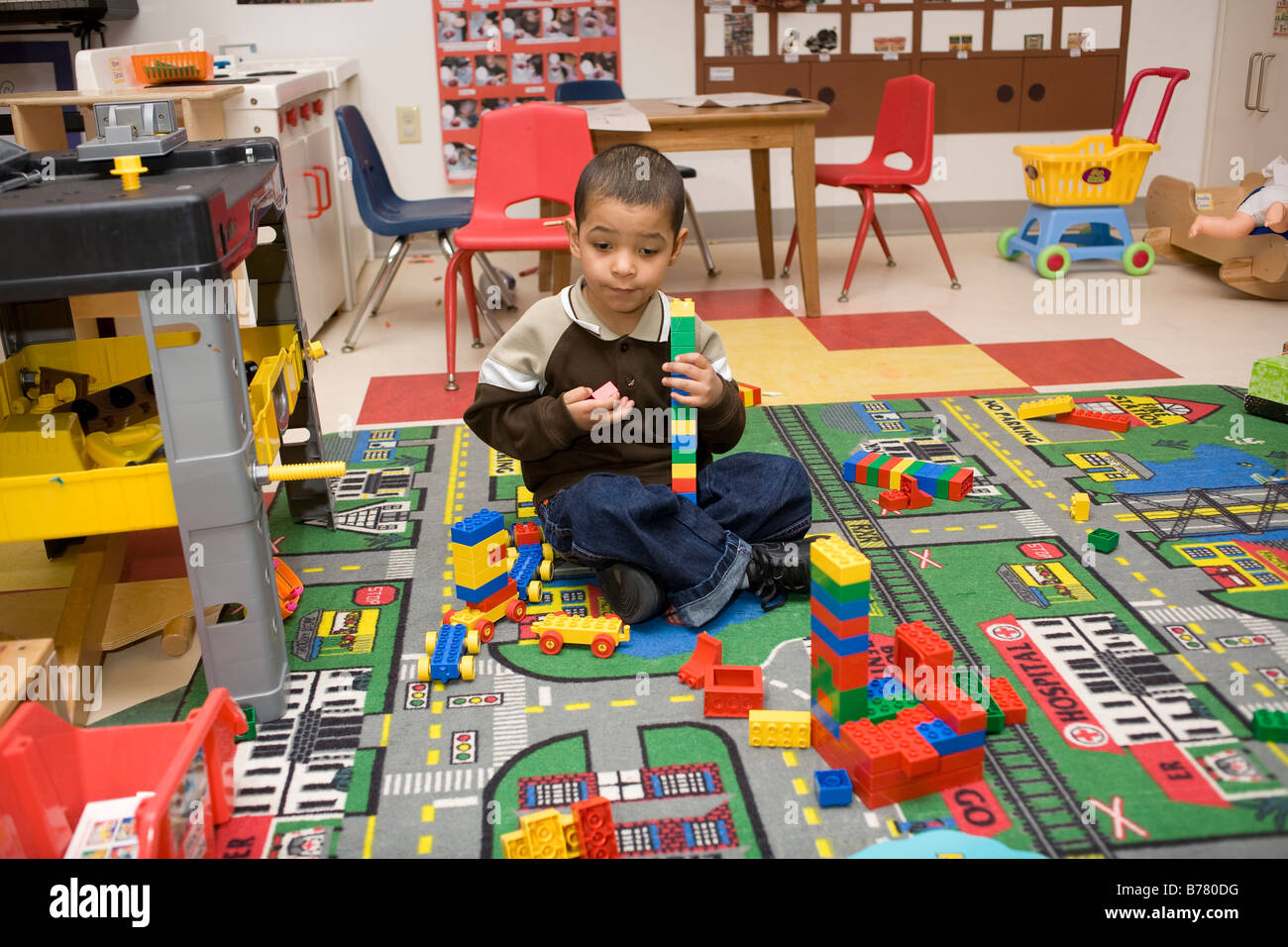 4 year old preschool boy playing on the floor Stock Photo - Alamy