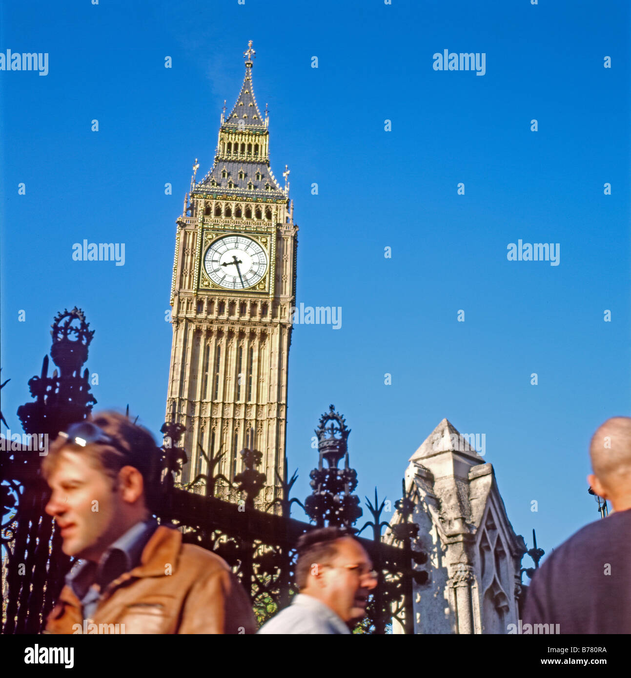 People walking outside the gates of Parliament with Big Ben in the ...