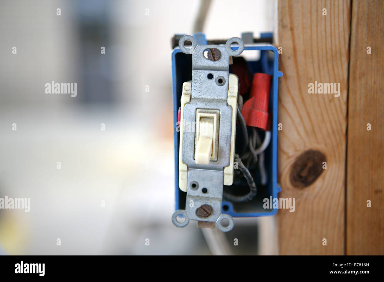 A single pole 120v light switch mounted on a wooden beam Horizontal ...