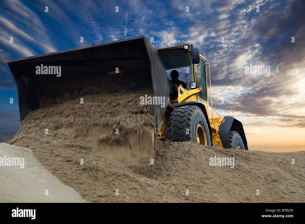 Bulldozer at work with sunset background Stock Photo - Alamy