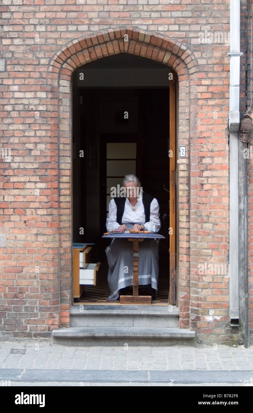 An old lady on a lace making loom in Brugge Stock Photo - Alamy