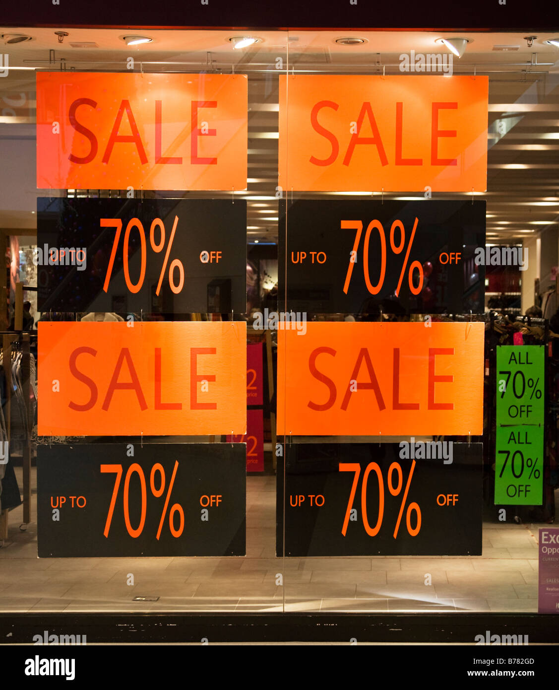 Sign in a retail store window advertising up to 70% off Stock Photo - Alamy