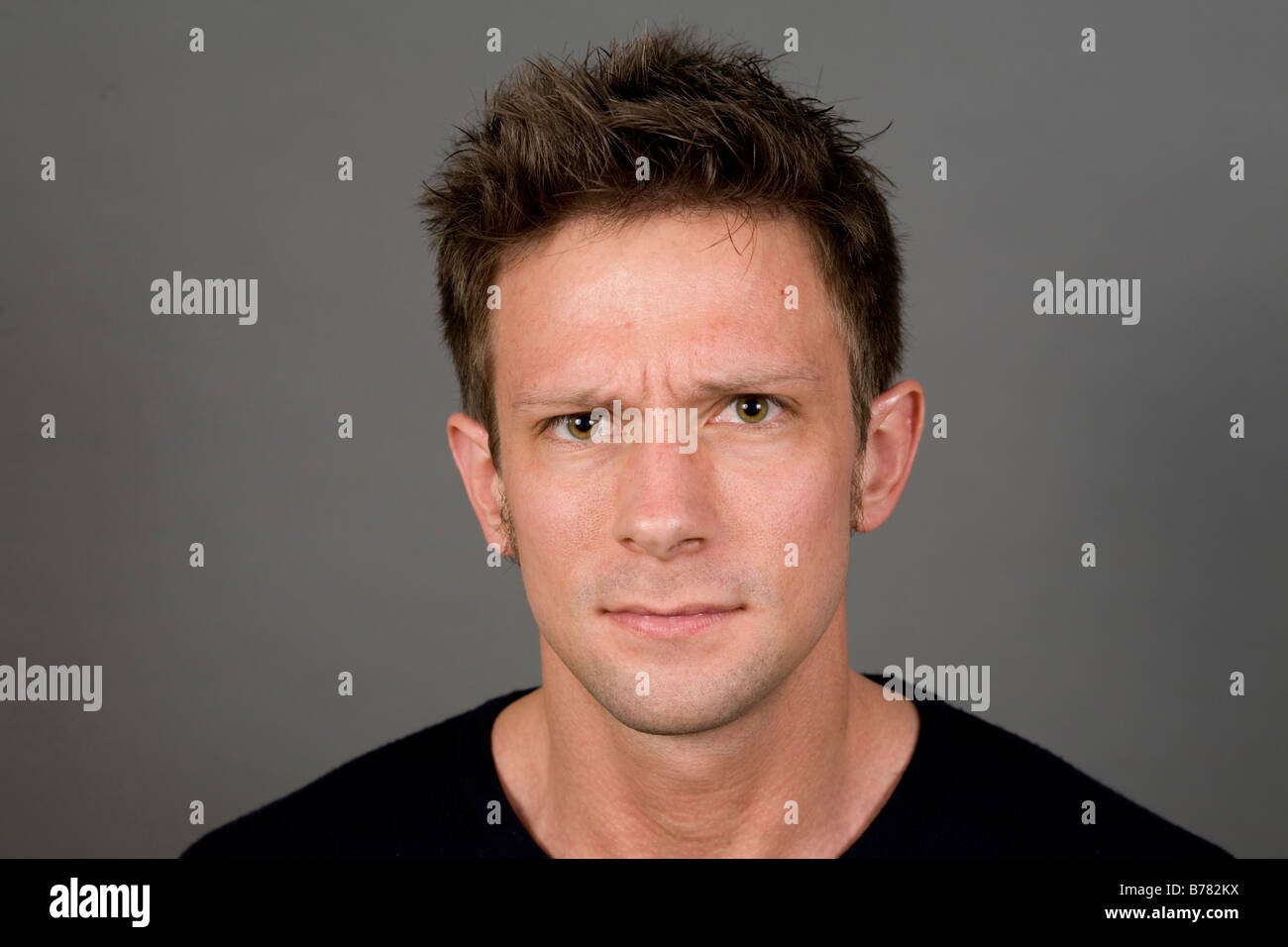 Young man serious, portrait Stock Photo - Alamy