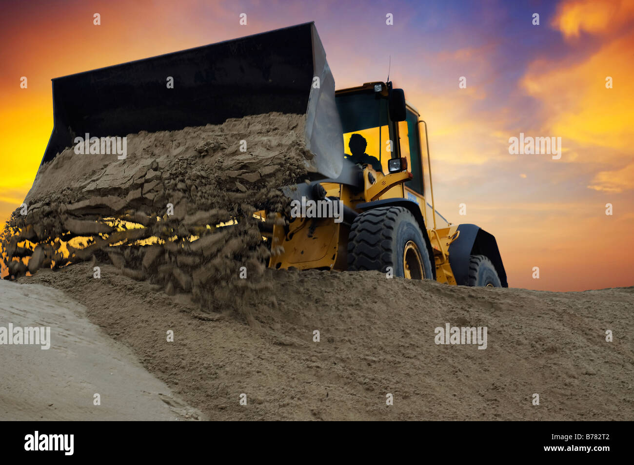 Bulldozer at work with sunset background Stock Photo - Alamy