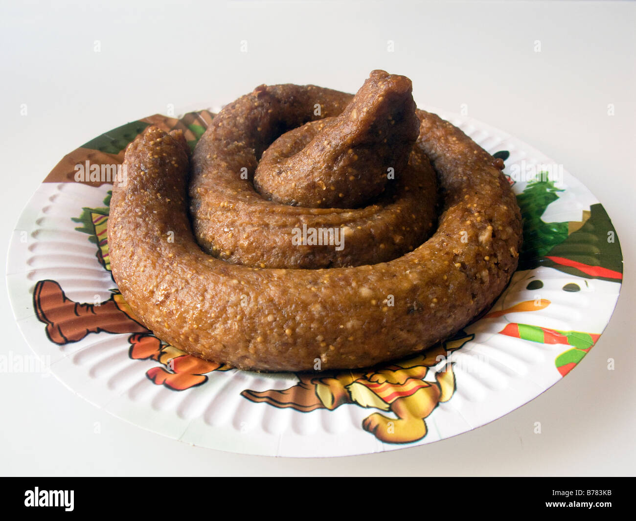 Fig turd on paper plate Stock Photo - Alamy