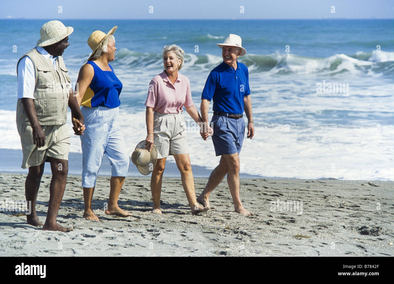 Seniors relaxing together, walking on beach, Miami Stock Photo - Alamy