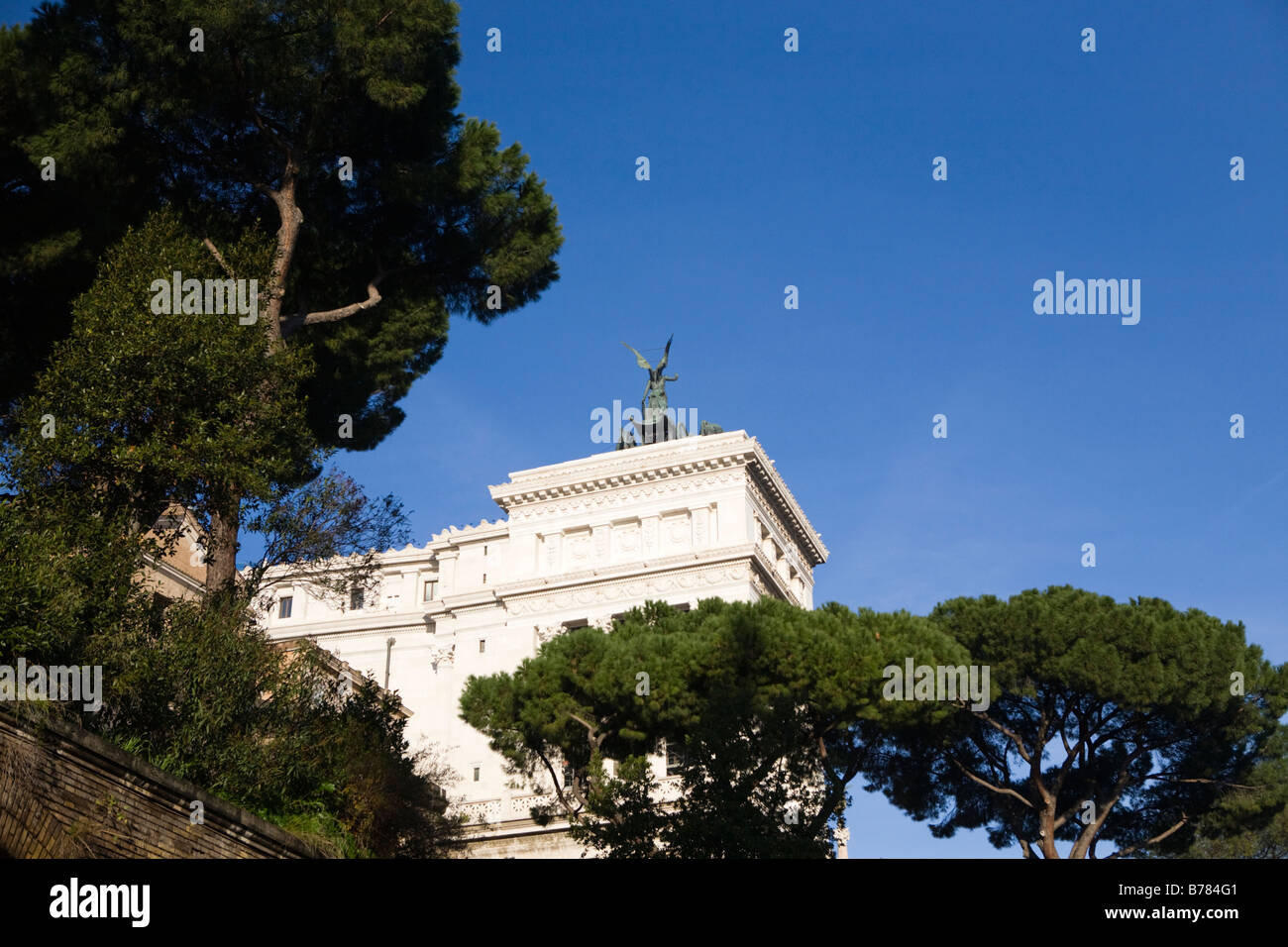 Monument to Vitorio Emanuale seen through trees on a clear Roman Day ...