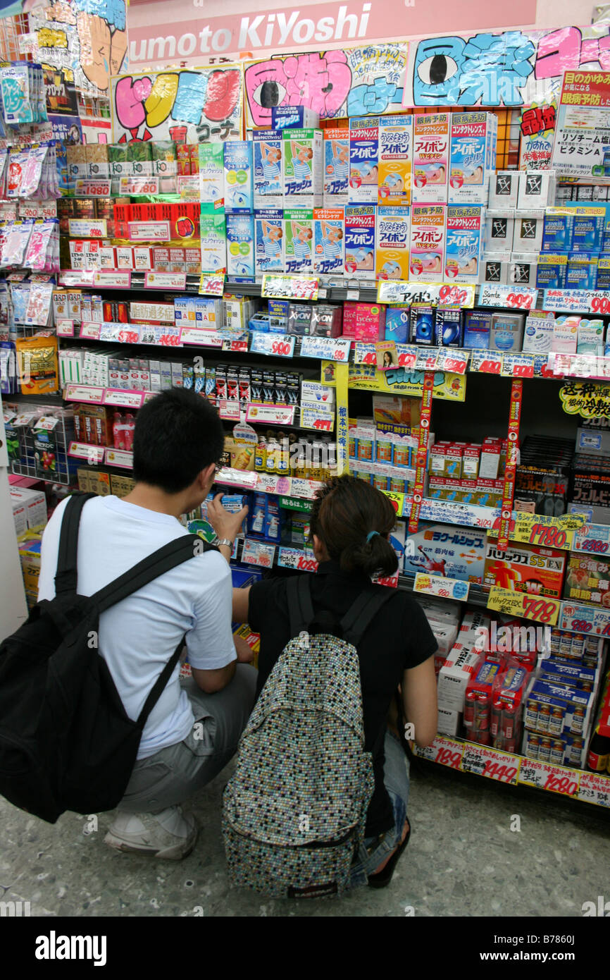 young couple making selection in pharmacy, Tokyo Japan, Drug store ...