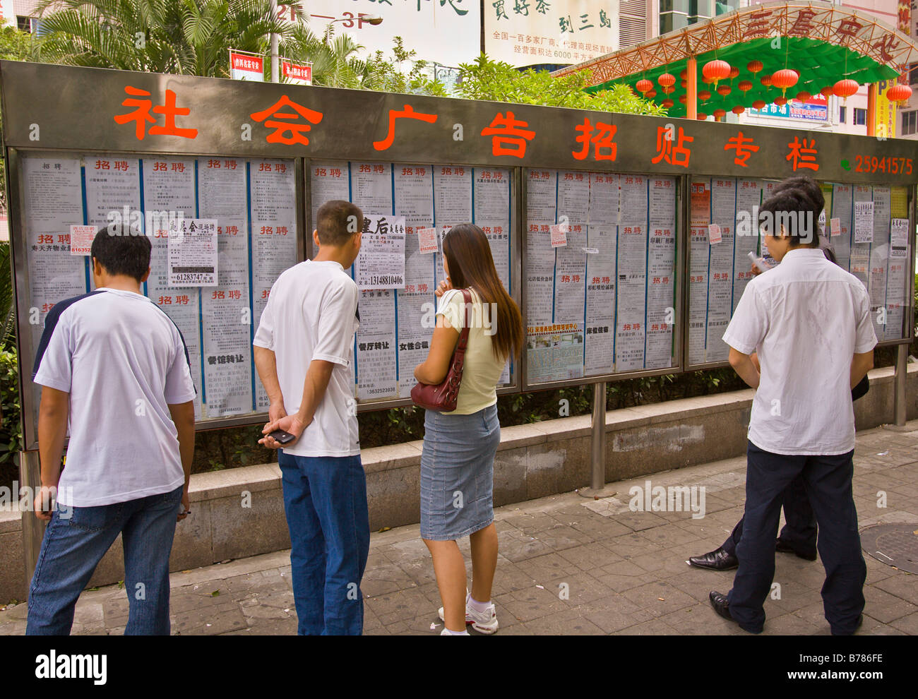 SHENZHEN, GUANGDONG PROVINCE, CHINA - People looking over help wanted ...