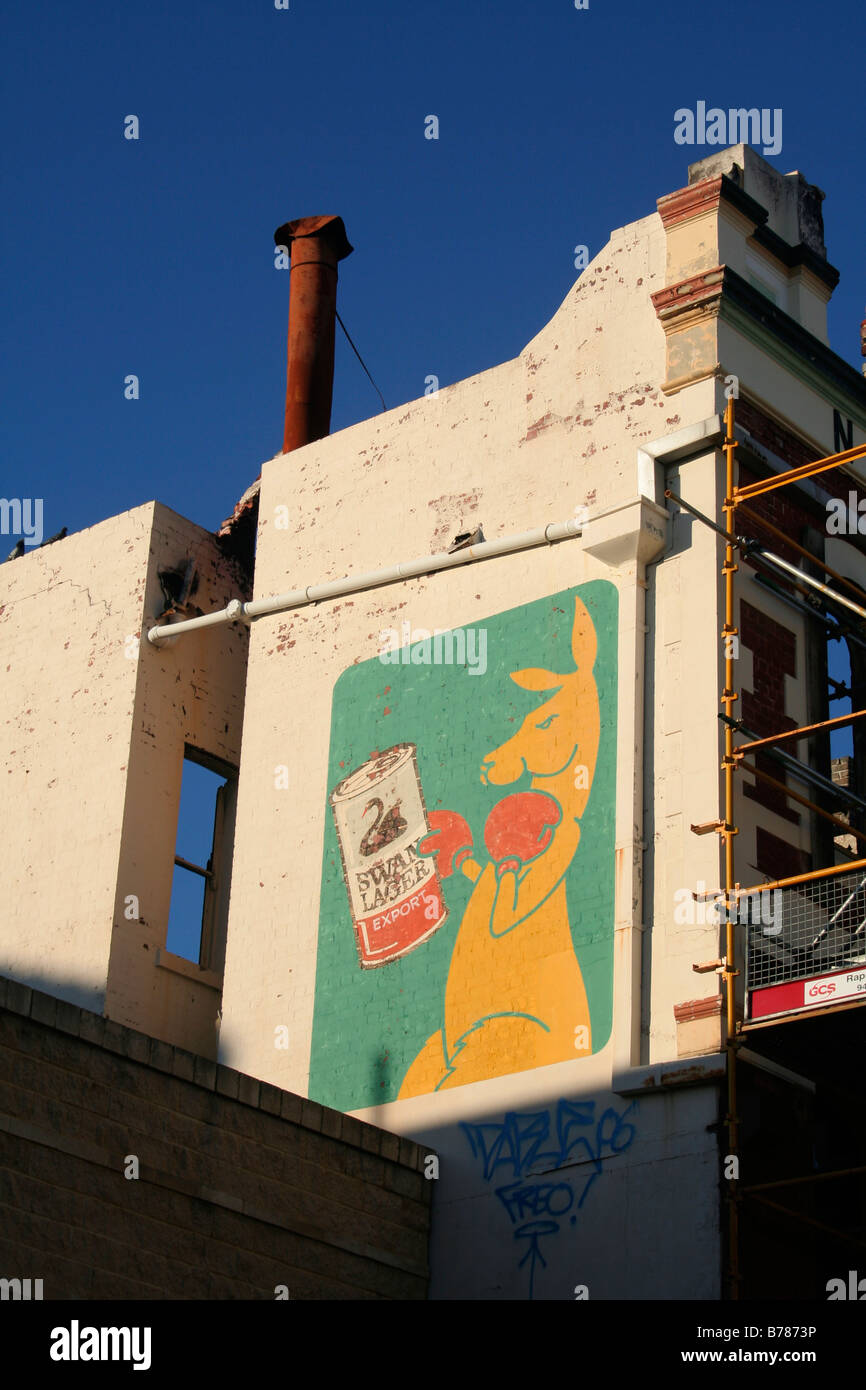 Swan Lager painted advert on side of building Stock Photo - Alamy