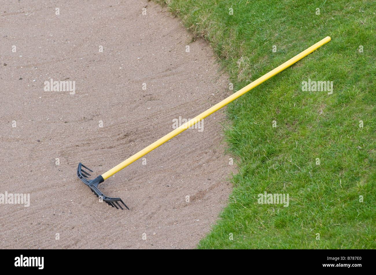 Rake in a sand bunker on a golf course Stock Photo - Alamy