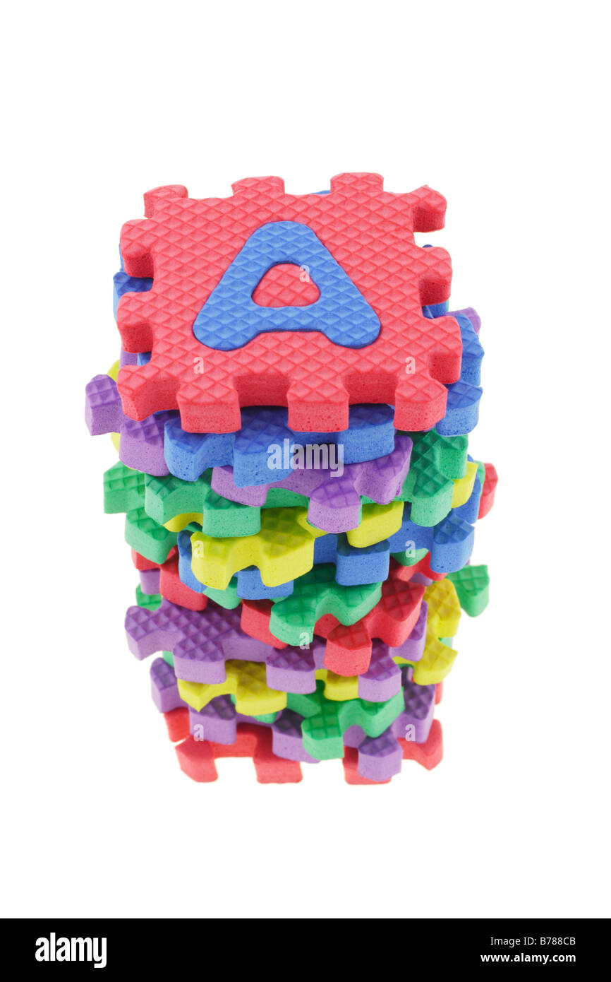 A stack of alphabet puzzle blocks on white background Stock Photo - Alamy