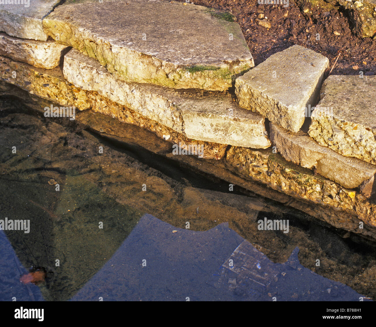 POND EDGING USING BROKEN CONCRETE SLABS Stock Photo - Alamy