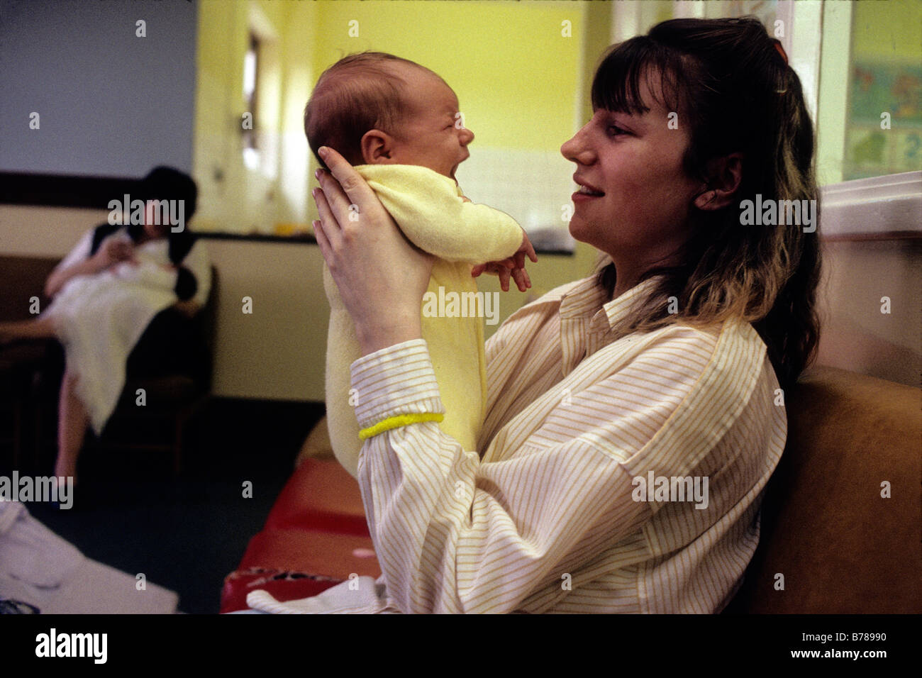 A young smiling inmate plays with her baby Stock Photo - Alamy