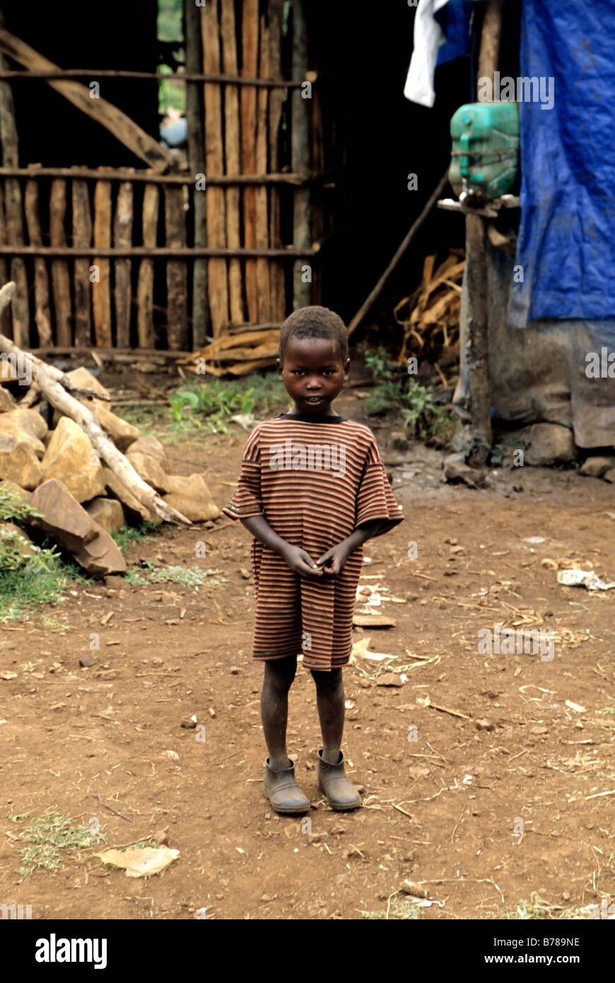 A cute boy stands next to his home Stock Photo - Alamy
