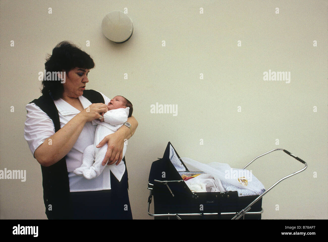 An inmate holds her baby son wrapped in a blanket Stock Photo - Alamy