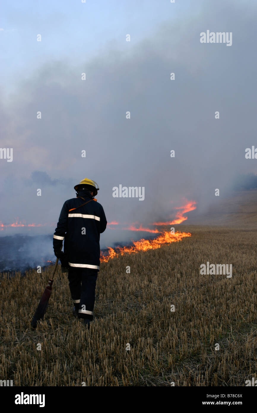 Fireman beating fire hi-res stock photography and images - Alamy