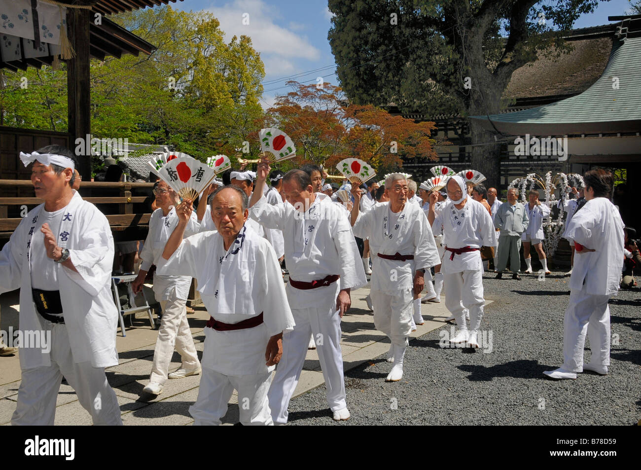 Handles of the shrines being carried accompanied by waving fans ...