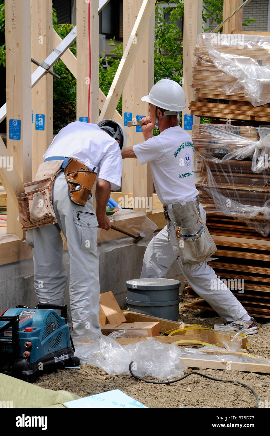 Assembly of a modern prefabricated house in light wooden framework ...
