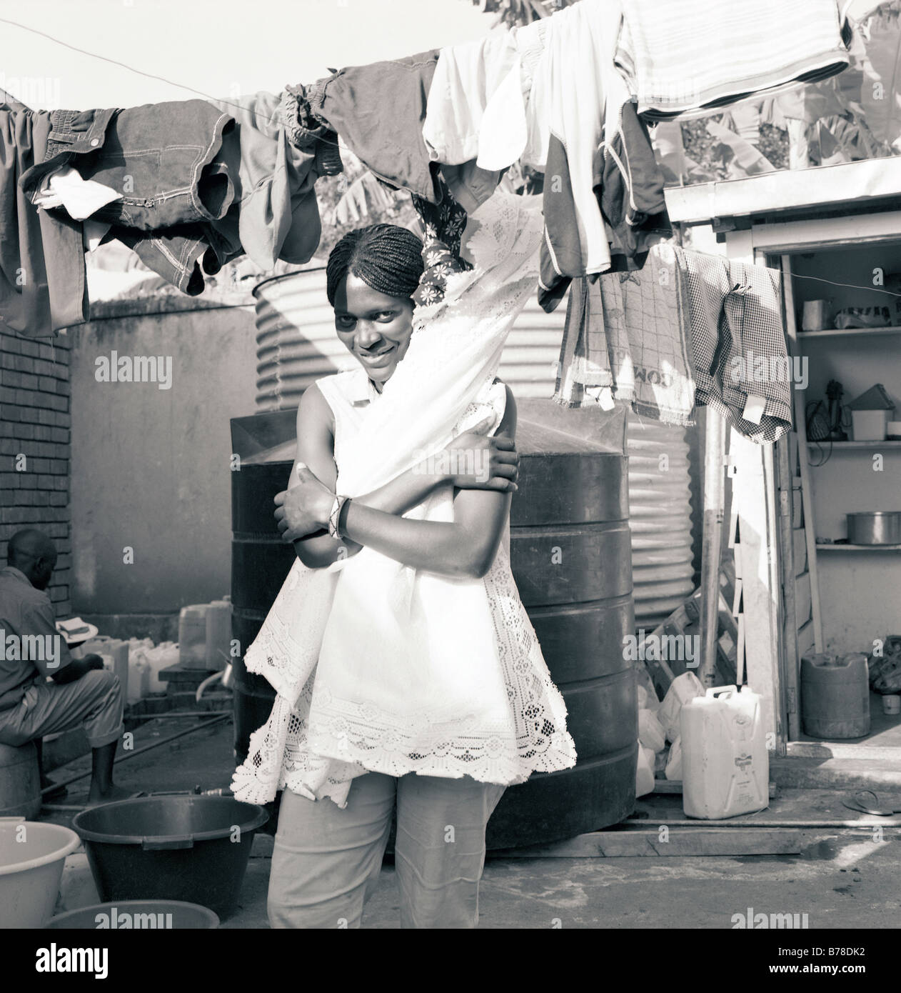 Female standing amongst laundry Stock Photo - Alamy