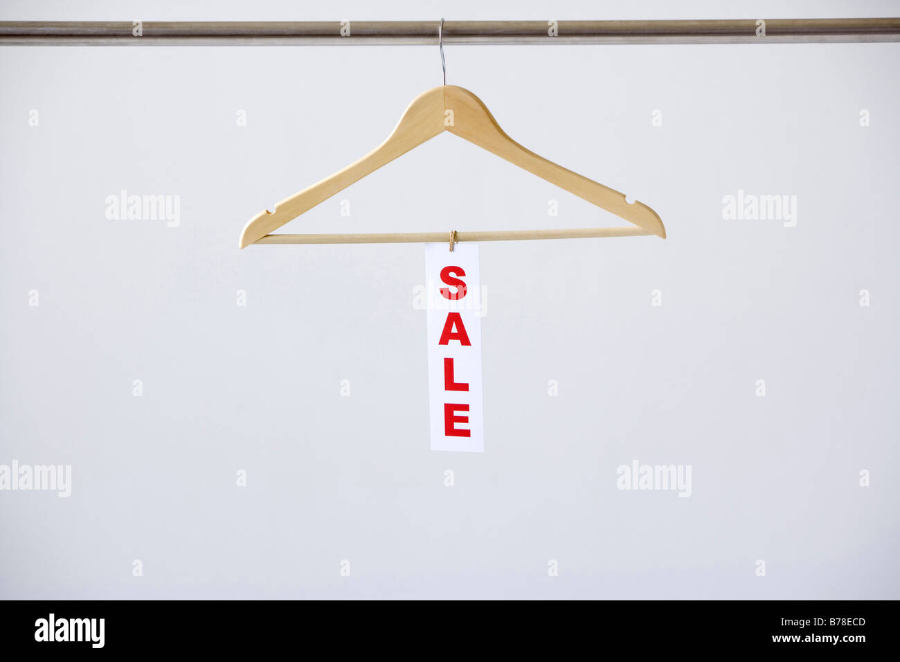 Hangers on hanger rack with sale sign Stock Photo - Alamy