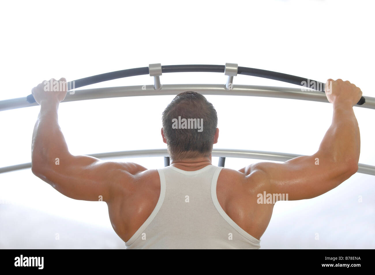 Man using weight machine, rear view, close-up Stock Photo - Alamy